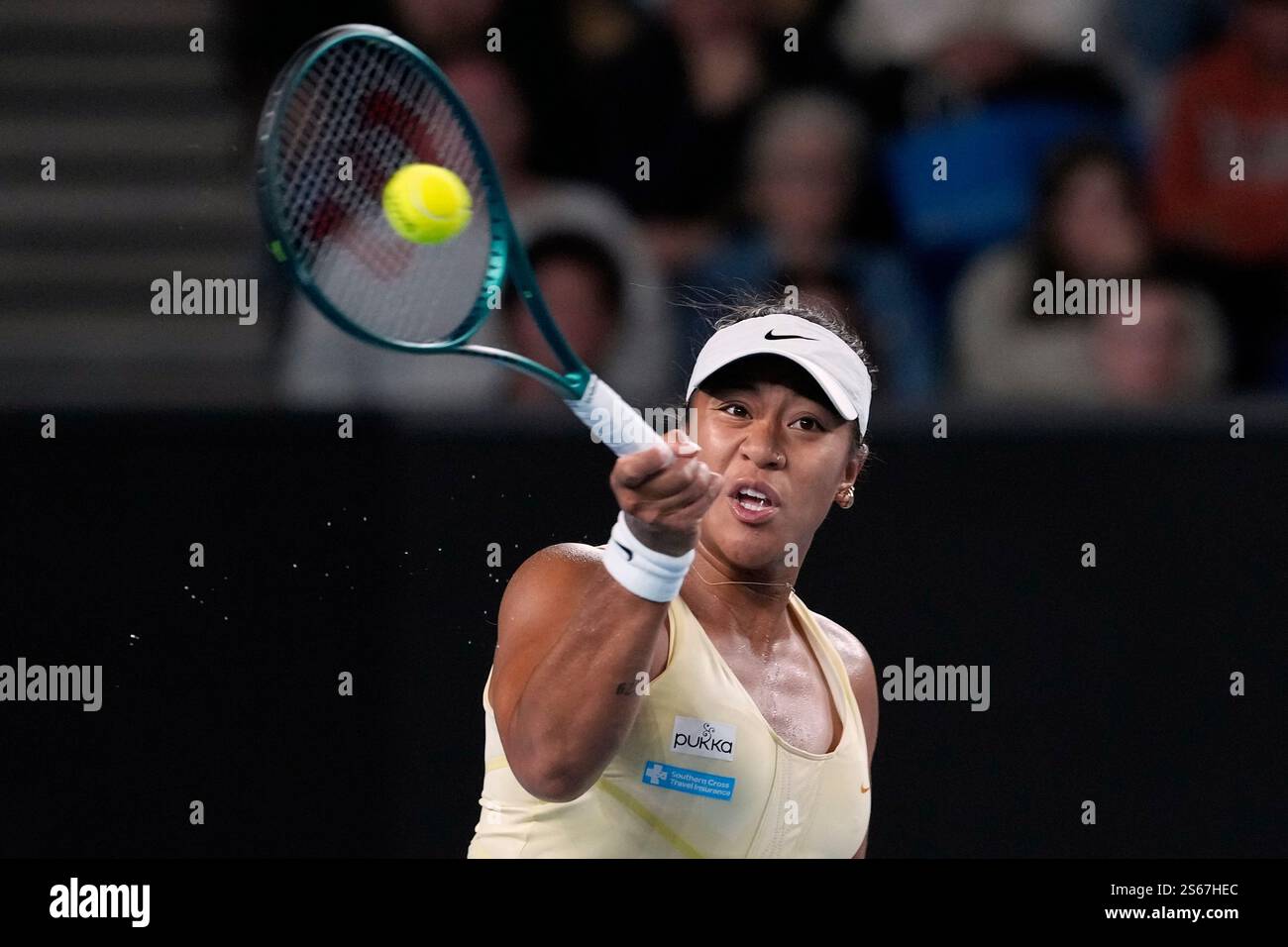 Destanee Aiava of Australia plays a forehand return to Danielle Collins ...