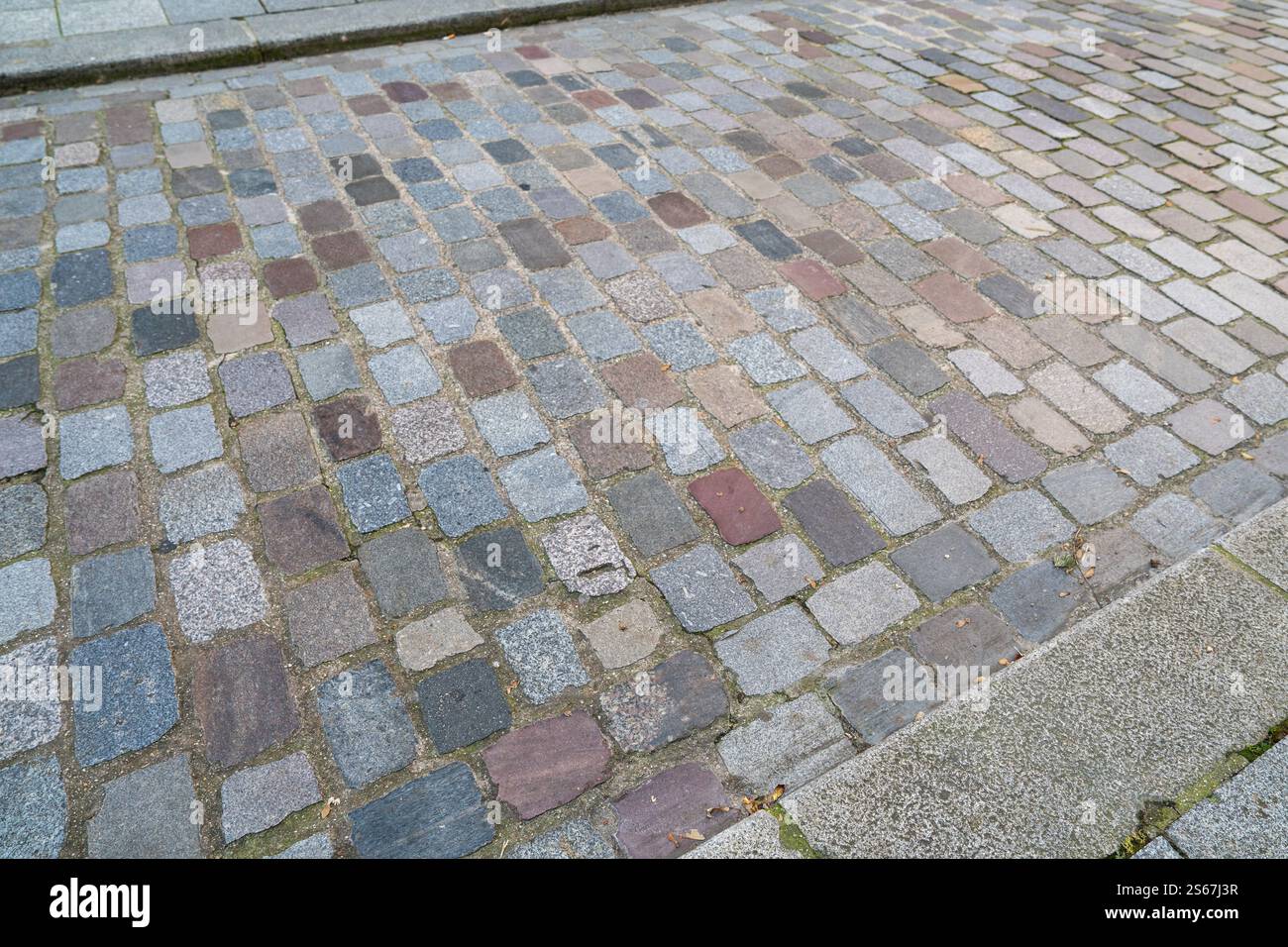 Cobblestone pavement showing a mix of colors and textures in a historic ...