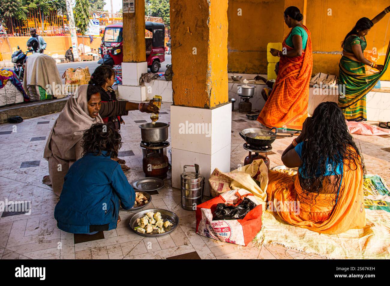 Life at Dhanushsagar Pond. Pilgrims bathing, washing clothes, and ...
