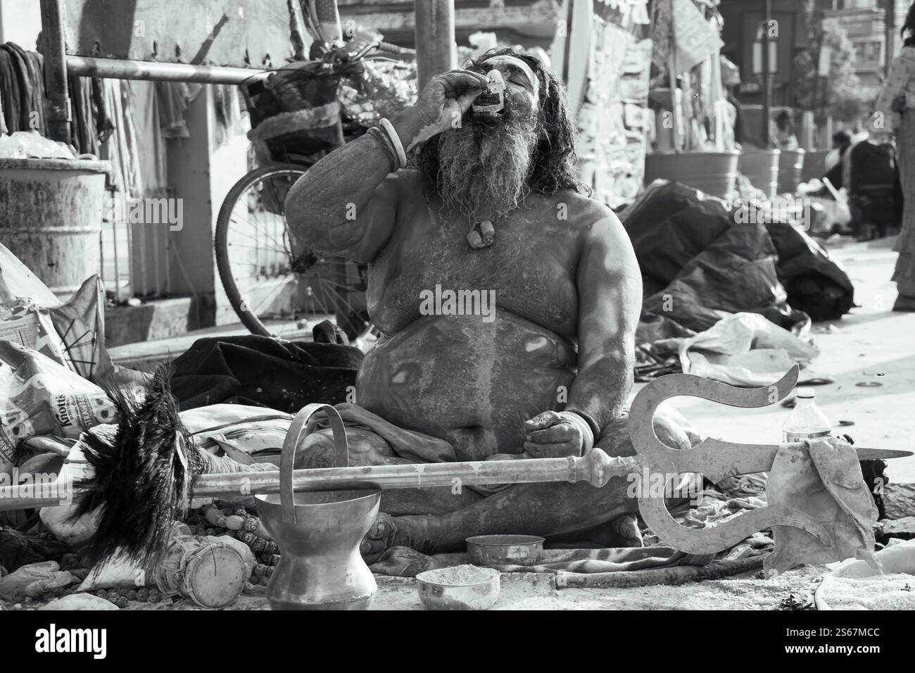 A Sadhu, an ascetic mendicant, with his trident and tobacco outside ...