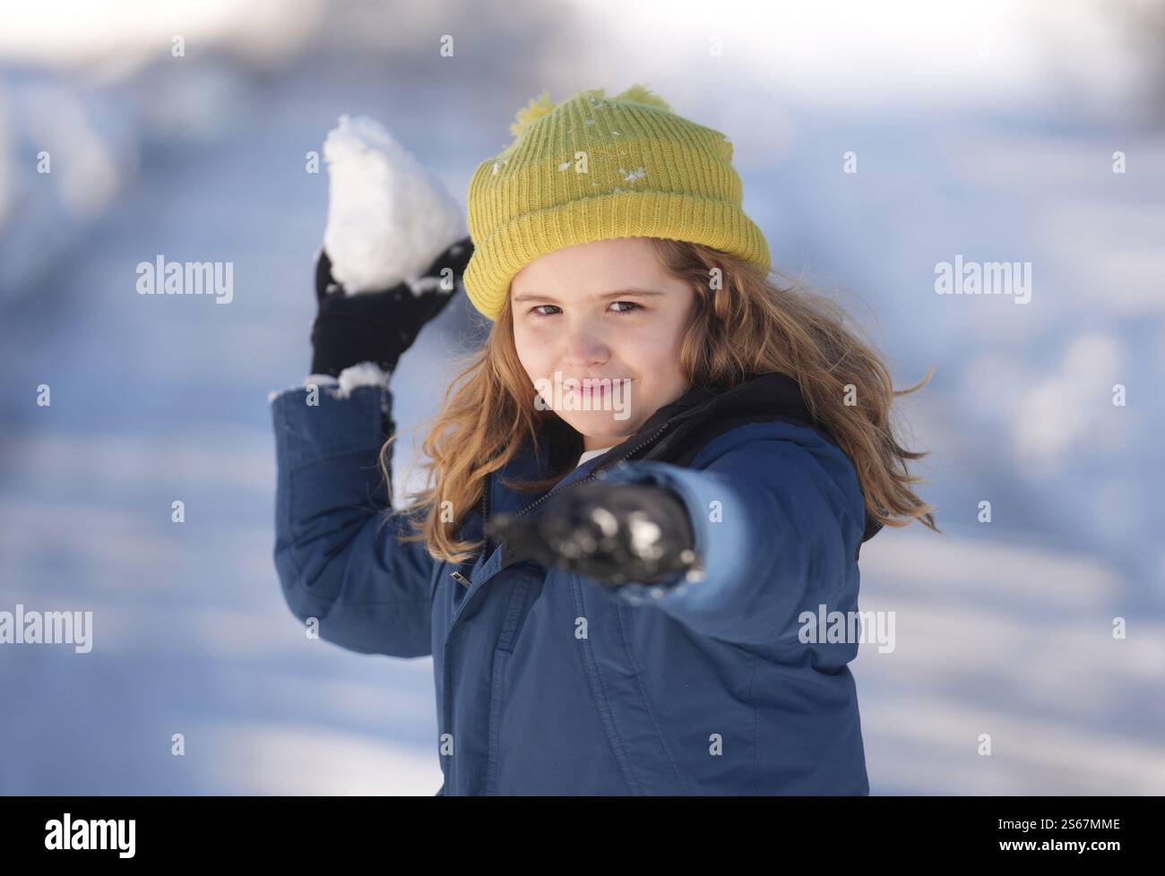 Child playing in Snowball fight. Kid boy Snowball fight in the snow ...