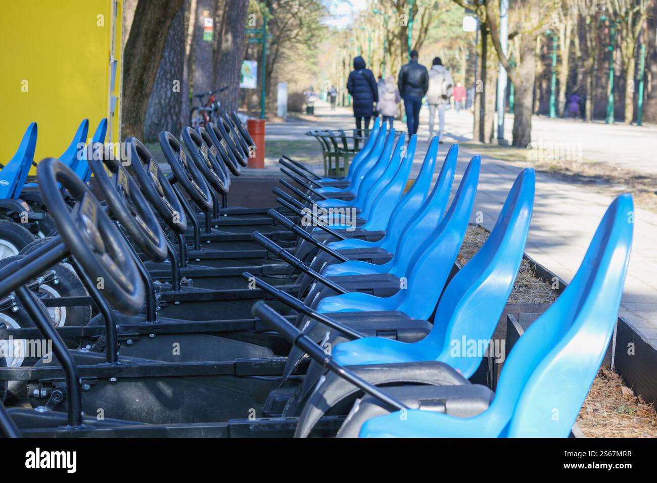 a row of row-a-row go-kart seats with bright blue seats Stock Photo - Alamy