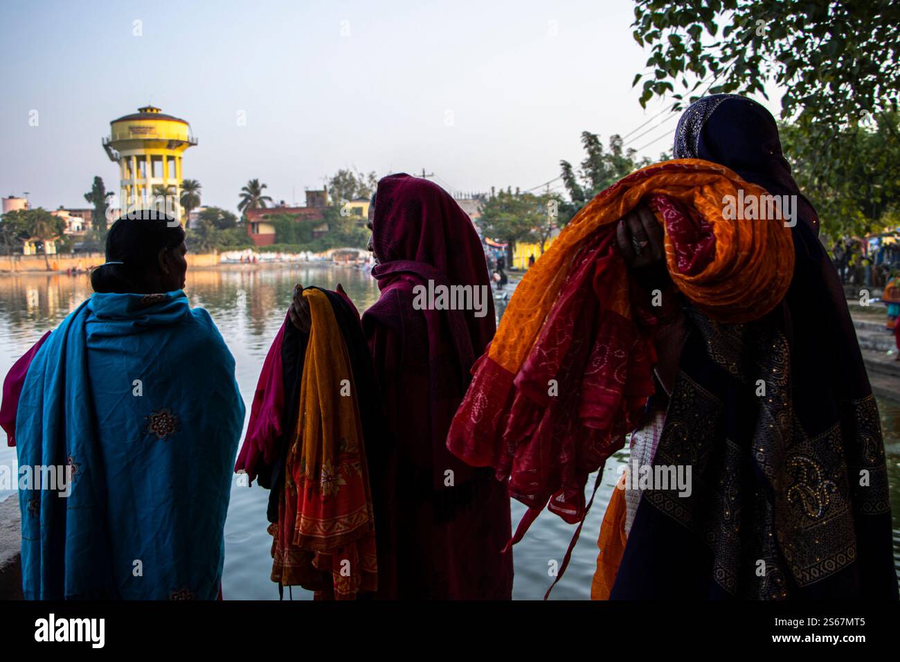 Hindu Pilgrims arrive at a pond in front of Janaki temple for morning ...