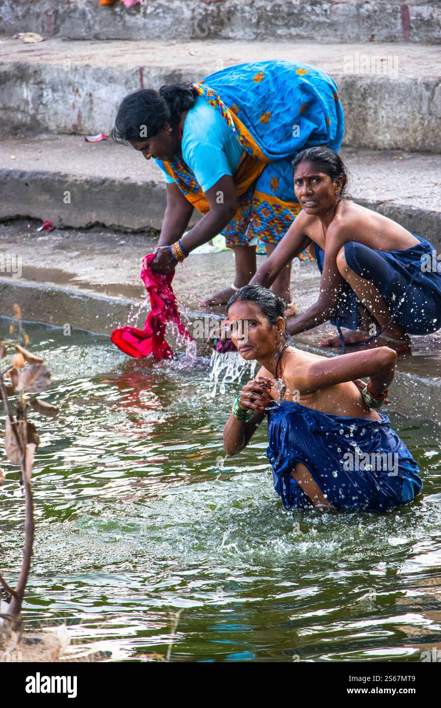 Hindu Pilgrims perform morning ablutions at a pond in front of Janaki ...