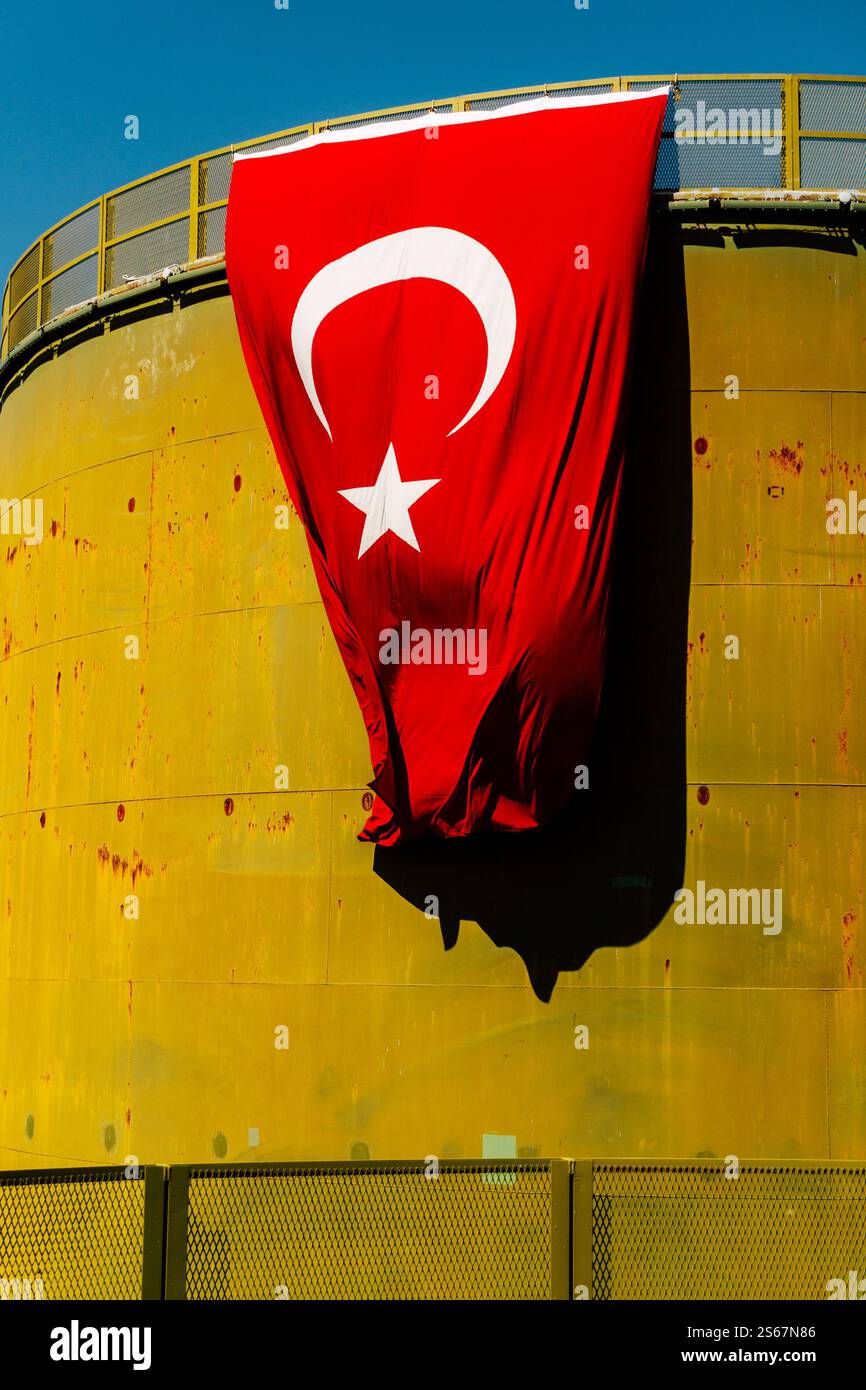 Turkish flag on the wall of a building. Red flag with a star and ...