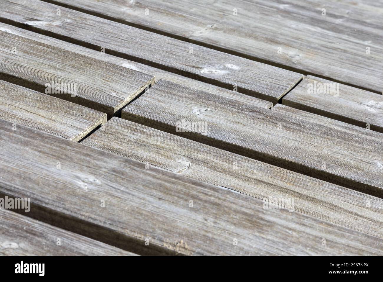 Close-up of worn wooden planks joined together to form a surface with ...