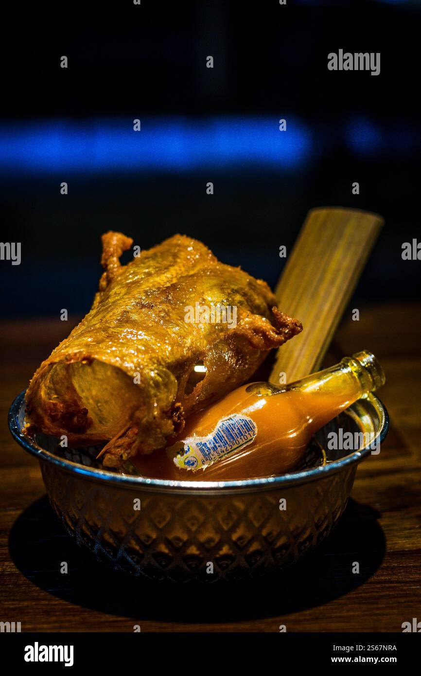 one piece of deep fried Chicken skin with home-made See-ra-cha sauce ...