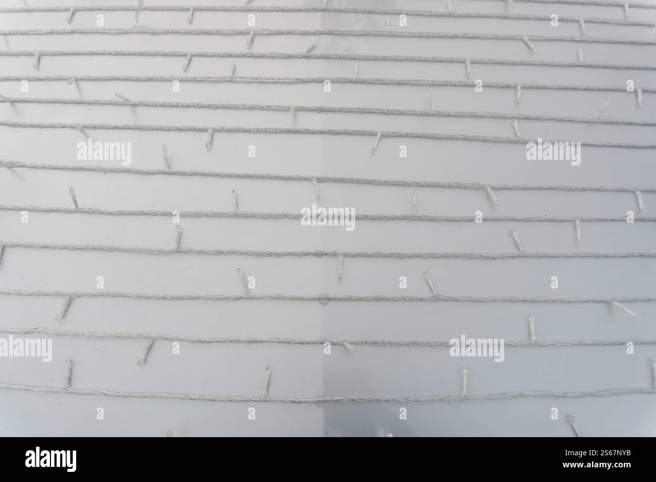 Christmas lights on the hood of the car. light bulbs on a wire attached ...