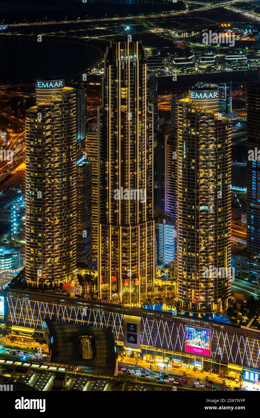 Bright lights of Dubai shot from Burj Khalifa. Skyscrapers intertwined ...