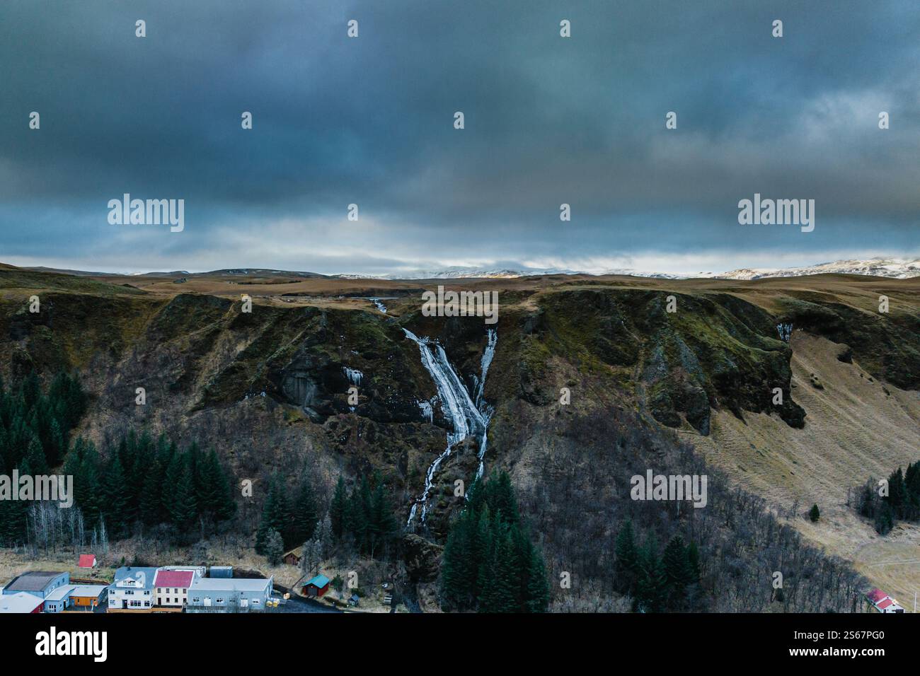 Aerial view of Systrafoss waterfall cascading over cliffs in ...