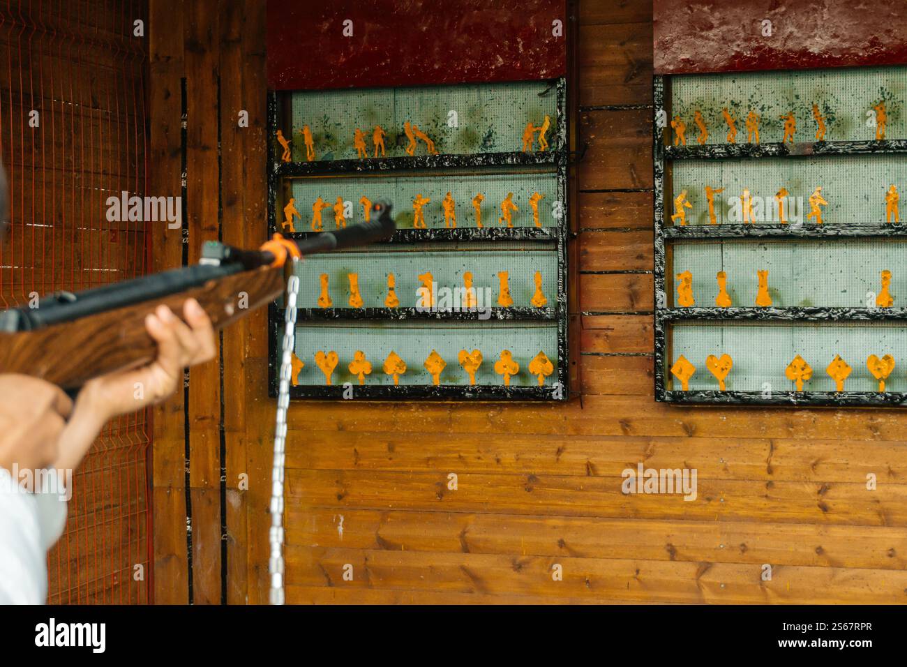 shooting with air guns in a shooting range. man shoots at targets with ...