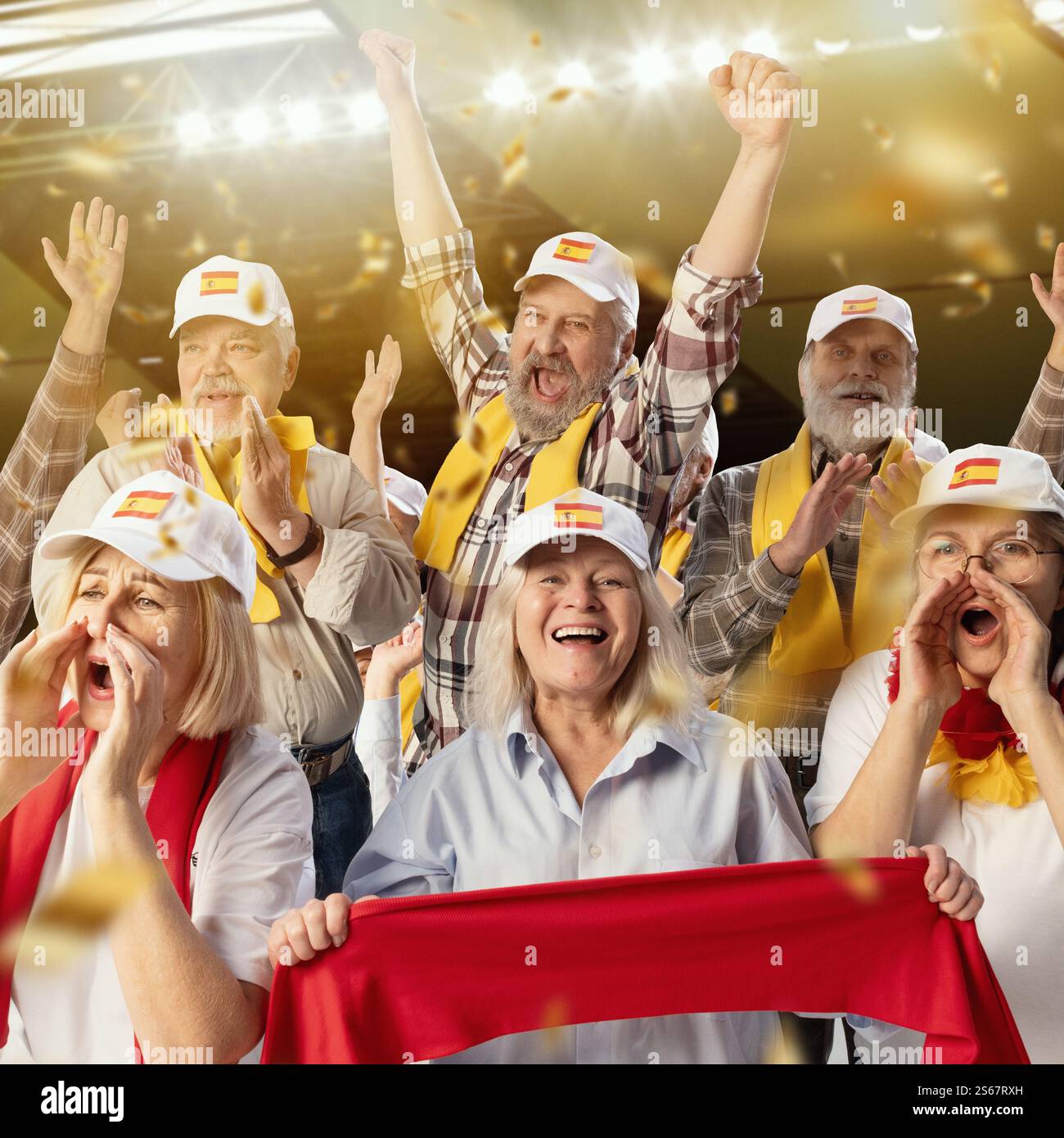 Energetic elderly fans in white caps and Spanish flags cheering ...