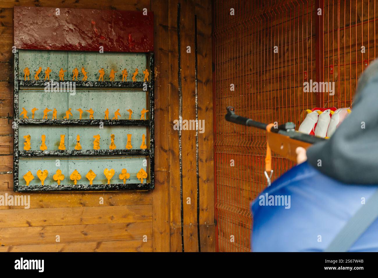 shooting with air guns in a shooting range. man shoots at targets with ...