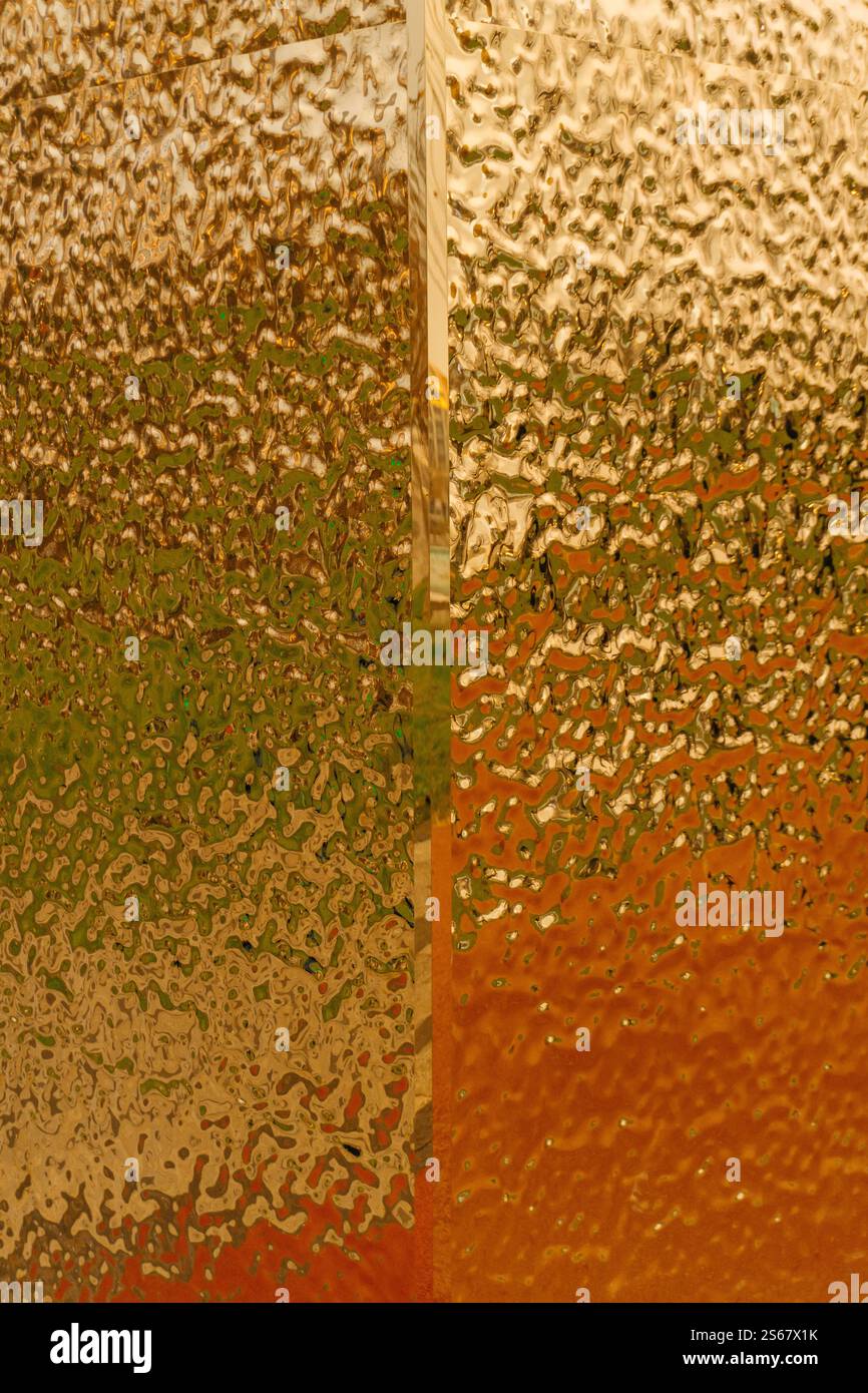 stamped gold-colored iron sheet. textured tin sheet on the wall Stock ...