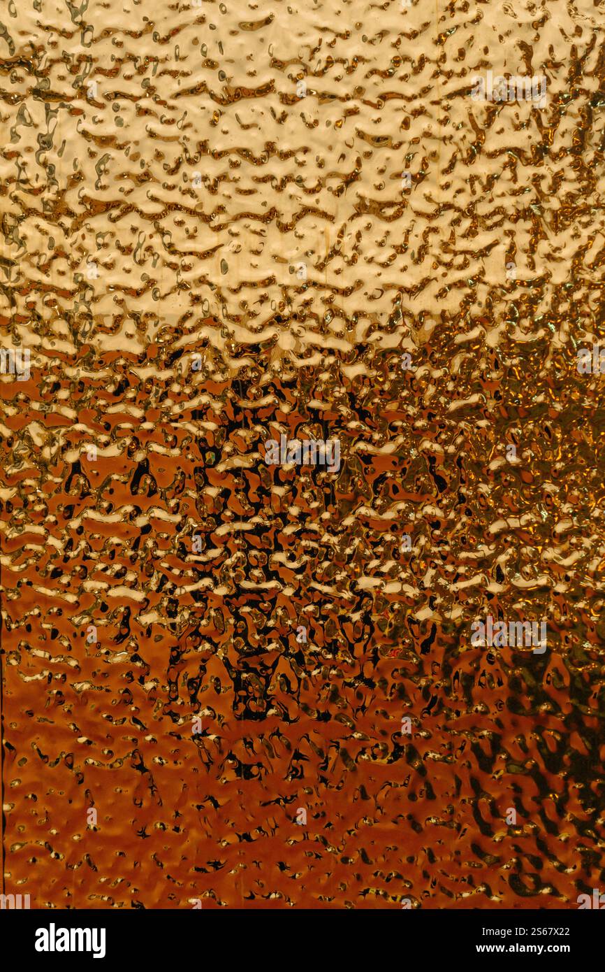 stamped gold-colored iron sheet. textured tin sheet on the wall Stock ...