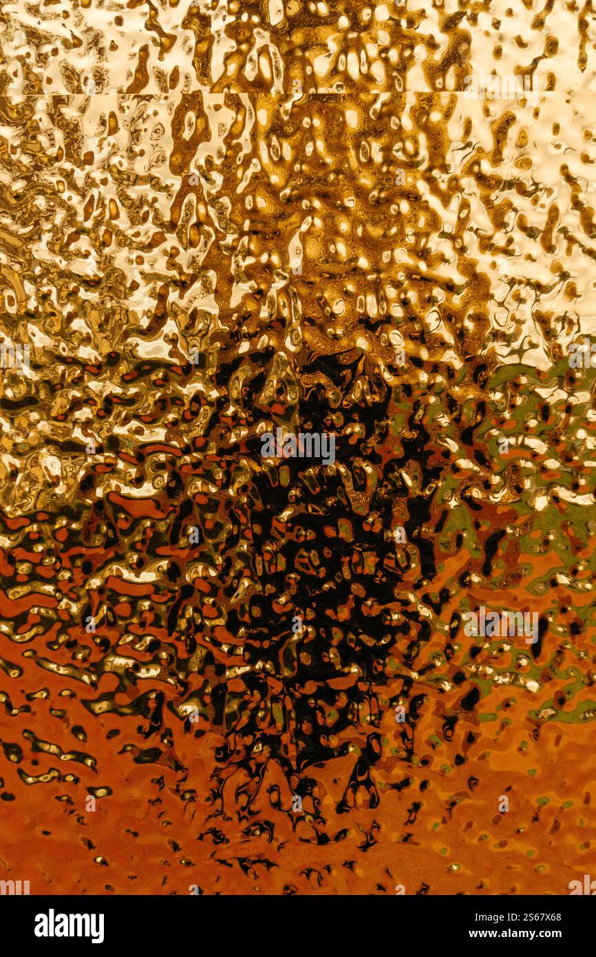 stamped gold-colored iron sheet. textured tin sheet on the wall Stock ...