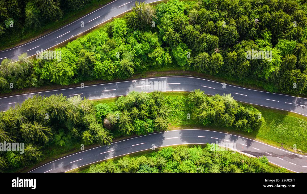 Aerial Perspective of Winding Road in Dense Alpine Forest Stock Photo ...