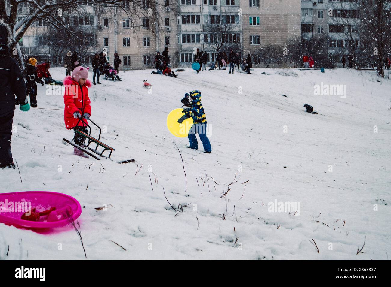 Kyiv, Ukraine December 1, 2022 Winter vacation. Children riding on ...