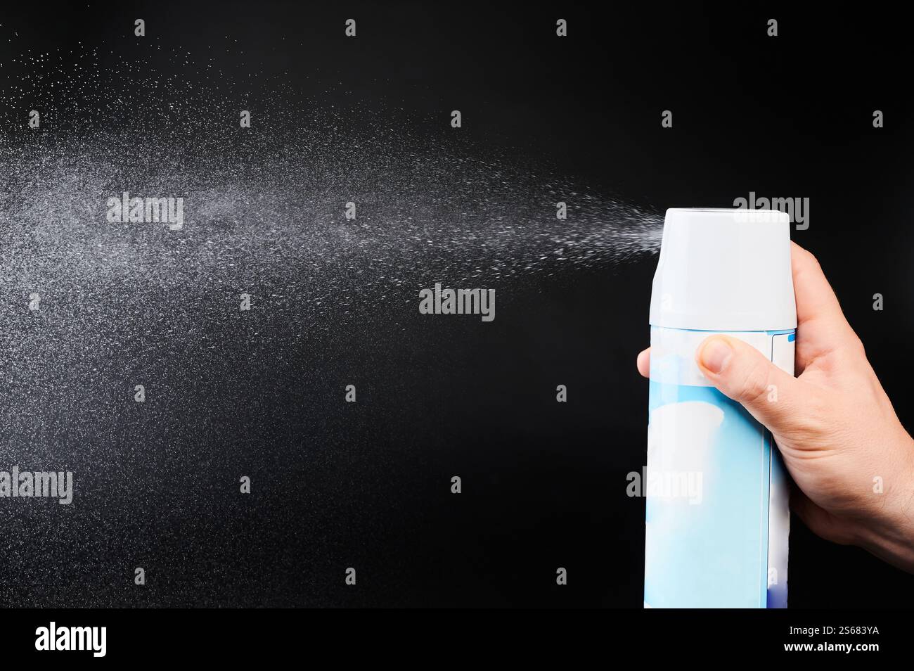 Aerozol chemical spray side view isolated on black studio background ...