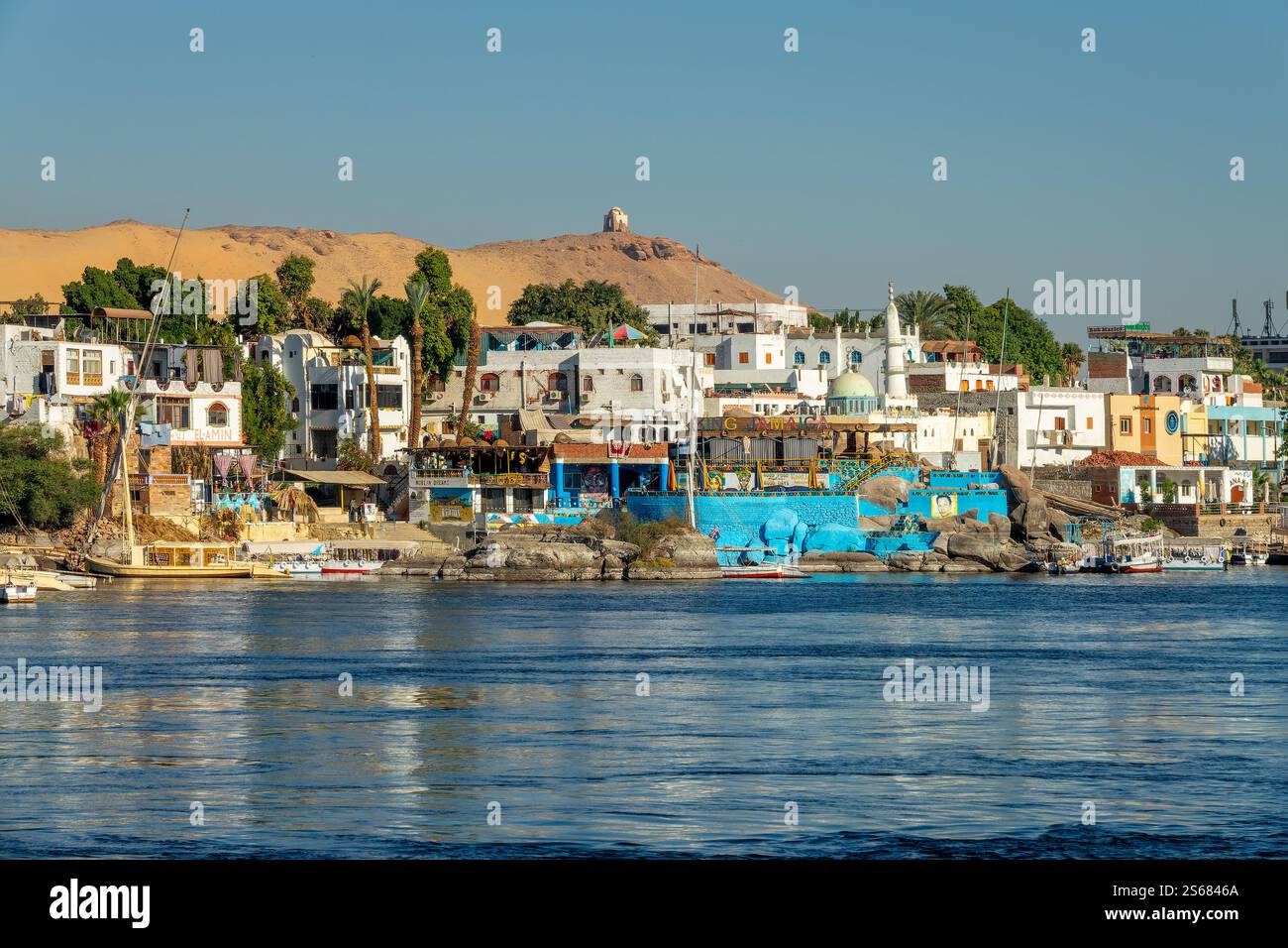 Colorful houses on Elephantine island and the Nile river in Aswan, dome ...