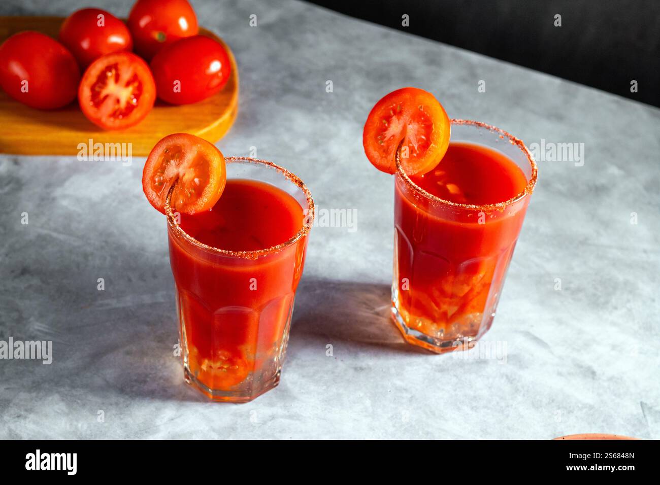 Two vegetable shaken cocktails in glass on dark grey background. Red ...