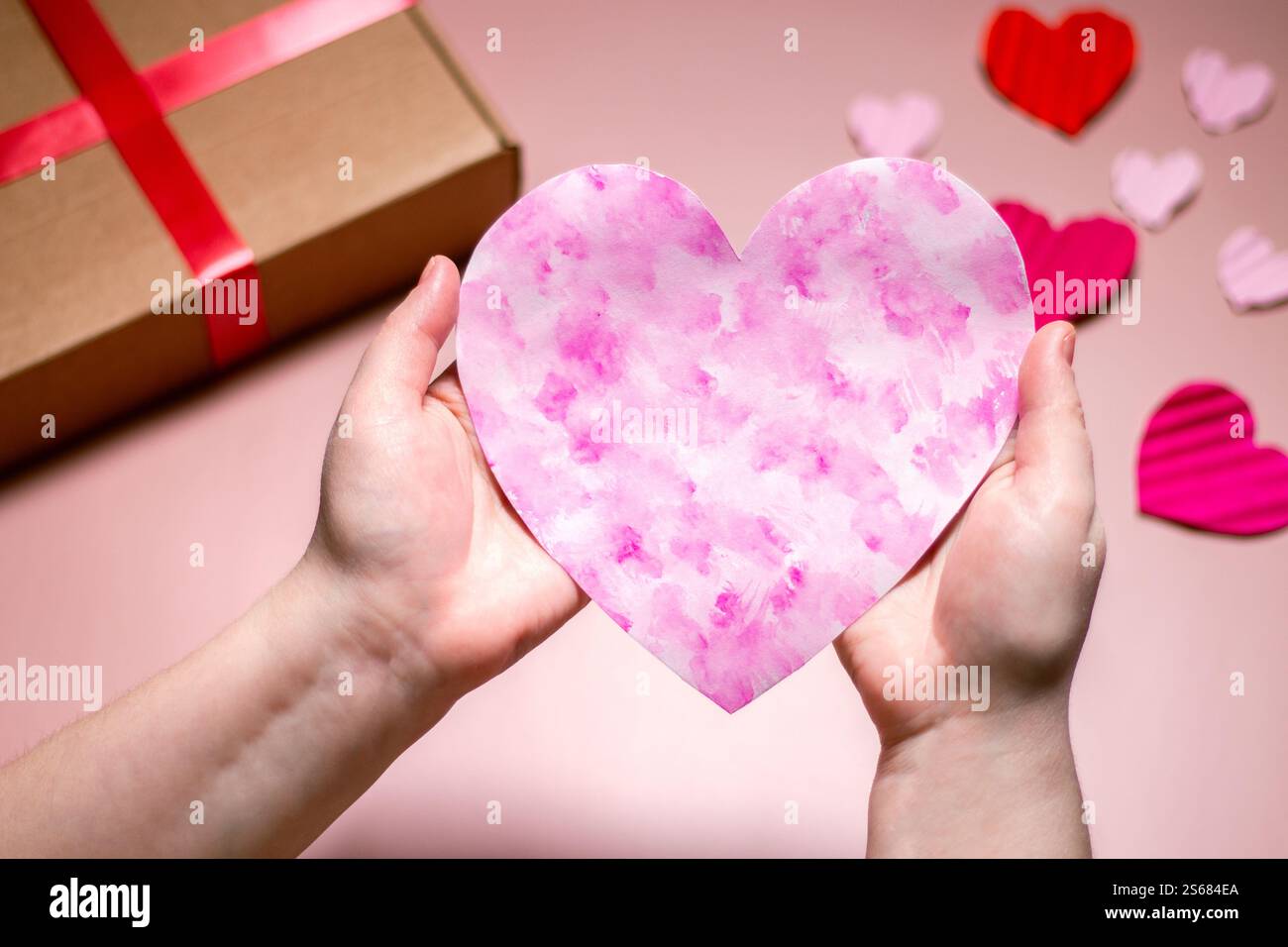 Pink valentines greeting card in hands. Handmade present for valentines ...