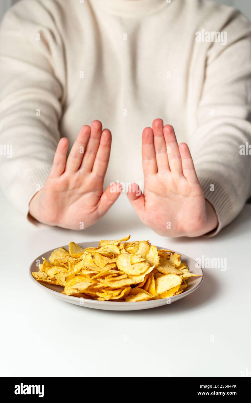 Woman pushing away plate with fried chips. No to fast food. Healthy ...