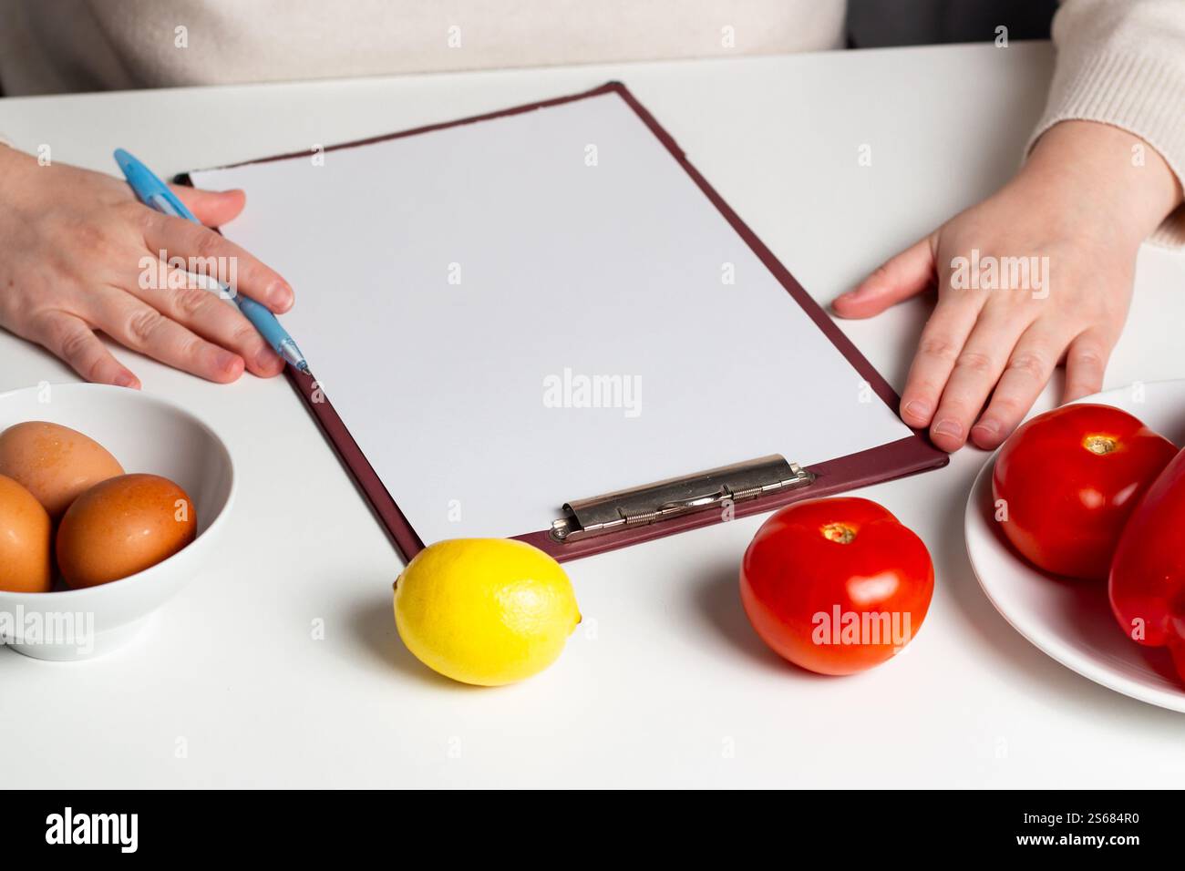 Nutritionist doctor writing down diet plan for patient. Healthy eating ...