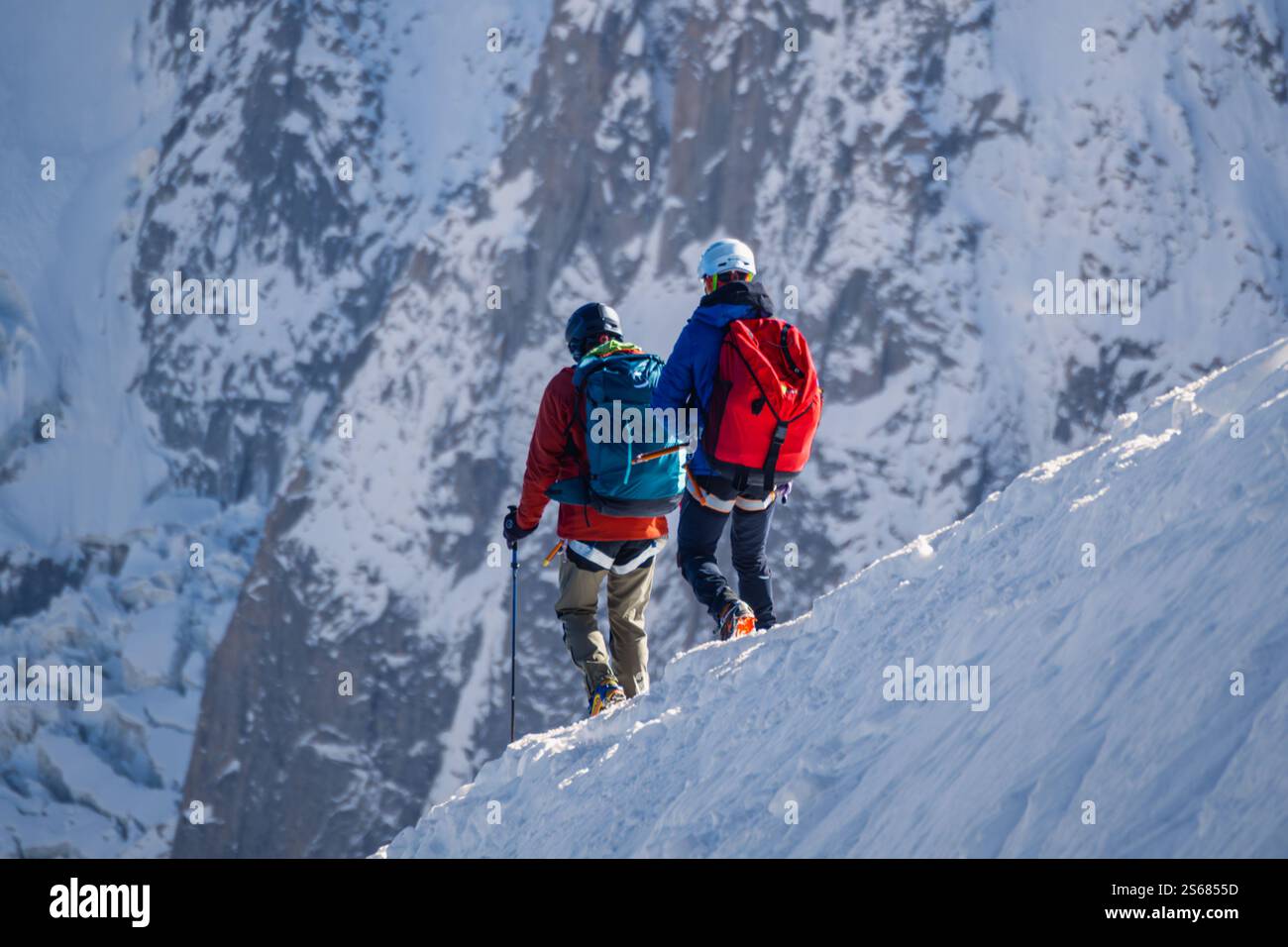 Paragliders with large backpacks with a parachute inside descend a ...