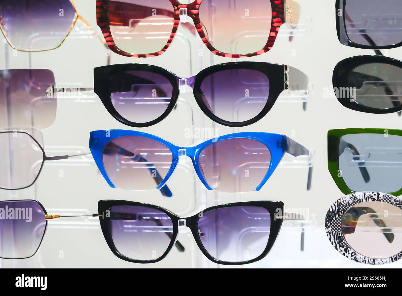 A display of sunglasses with a variety of colors and styles. Scene is ...
