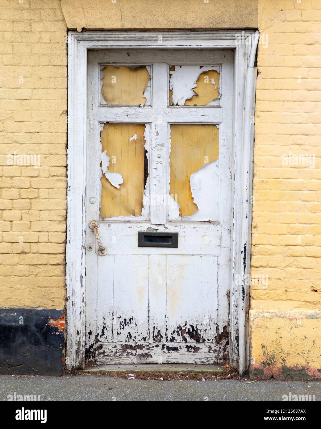 The broken front door of a derelict property in the United Kingdom ...