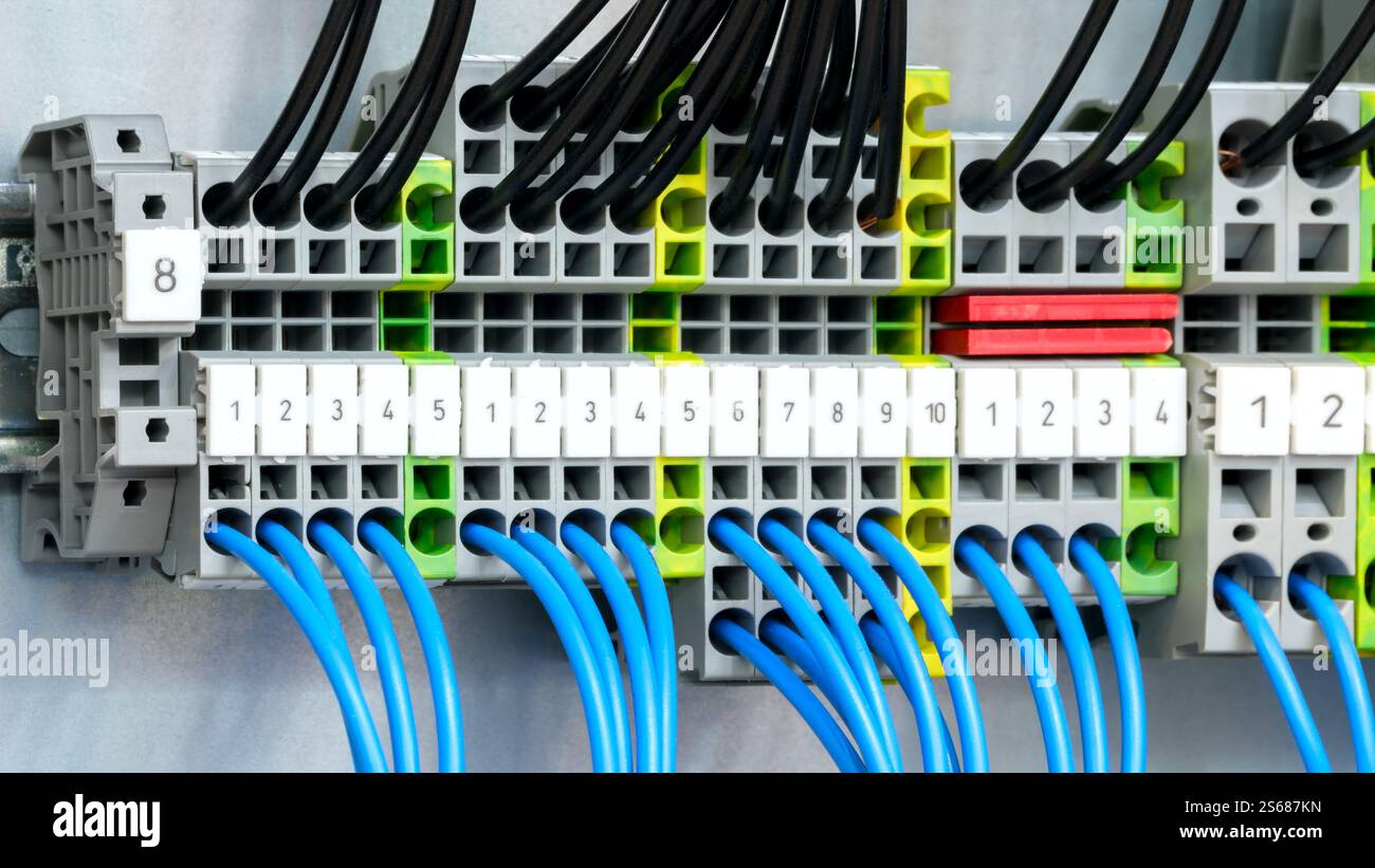 A bunch of wires are connected to a device. The wires are blue and ...