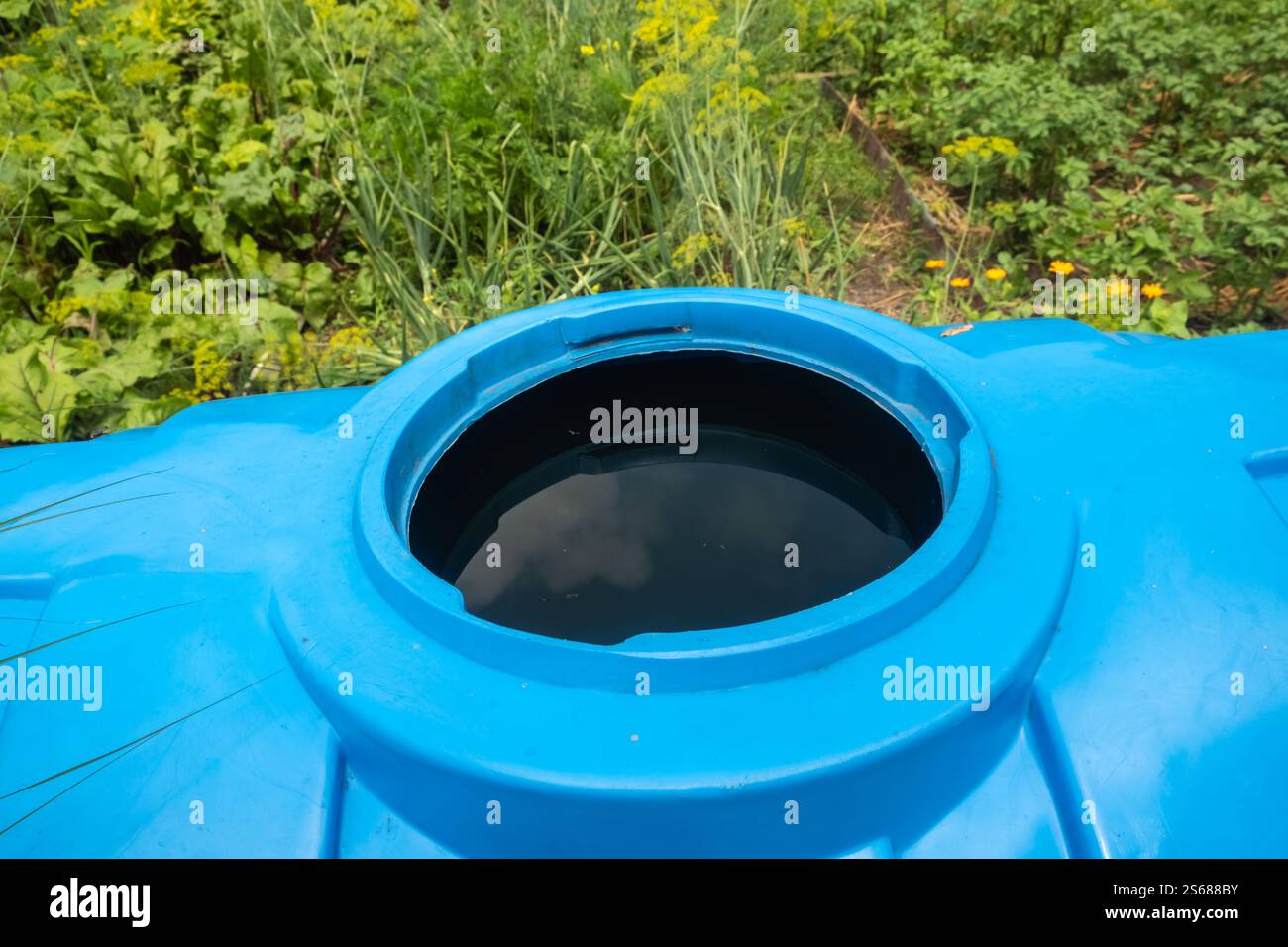 water collection tank under a roof with a drain. Rain water harvesting ...