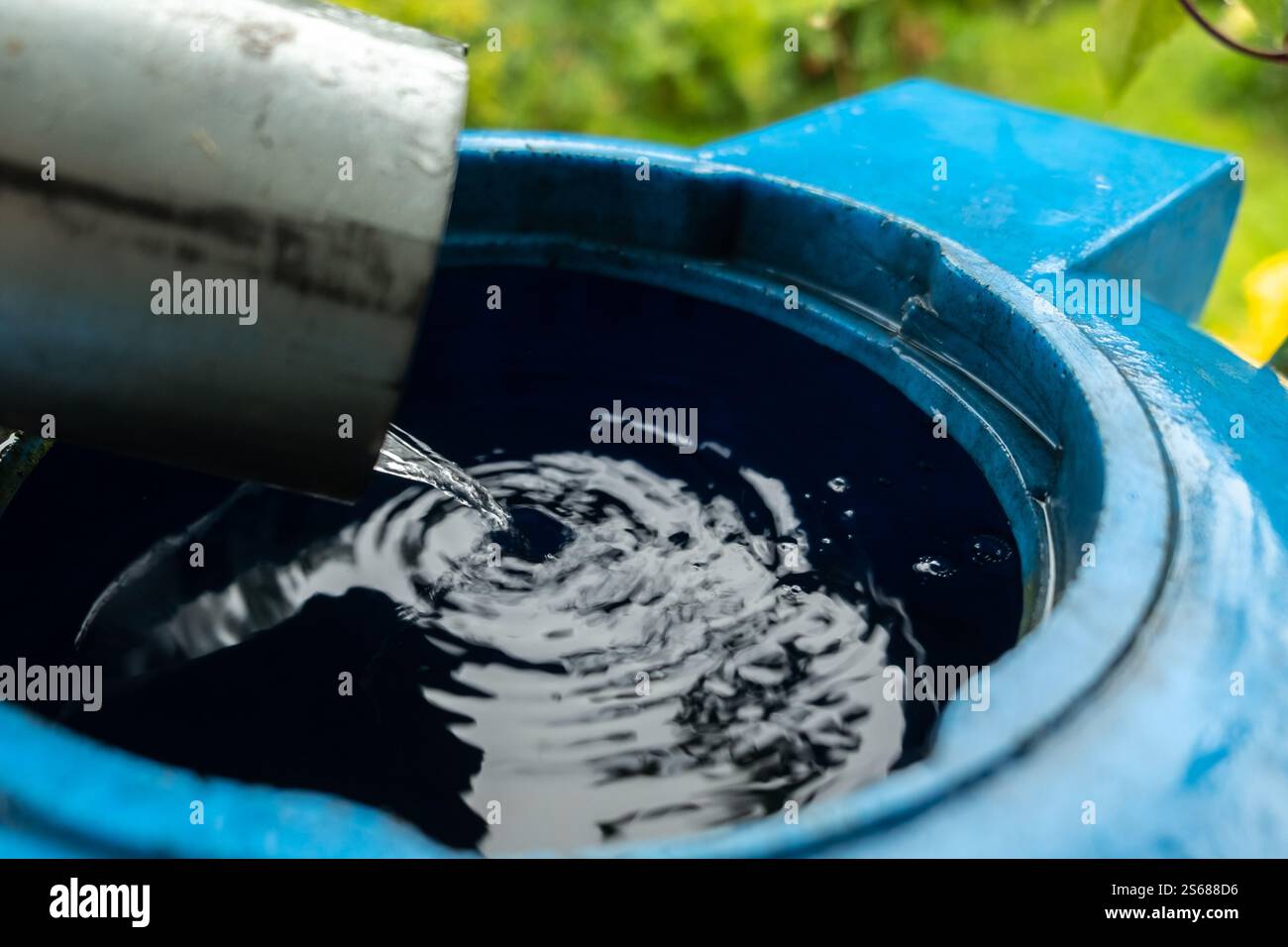 water collection tank under a roof with a drain. Rain water harvesting ...