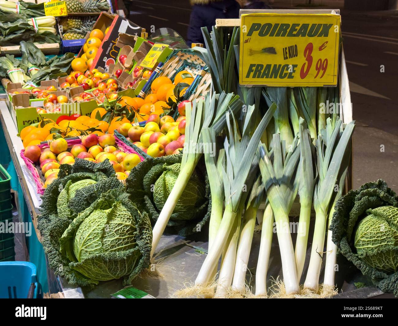 Fresh produce stand showcasing leeks, cabbage, and assorted fruits at ...