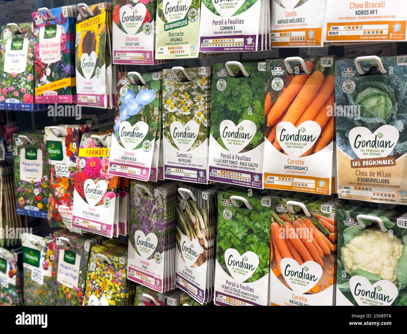 Gardening supplies display in store featuring various seed packets ...