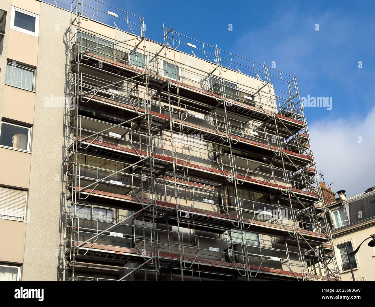 Renovation work underway on residential building with scaffolding ...