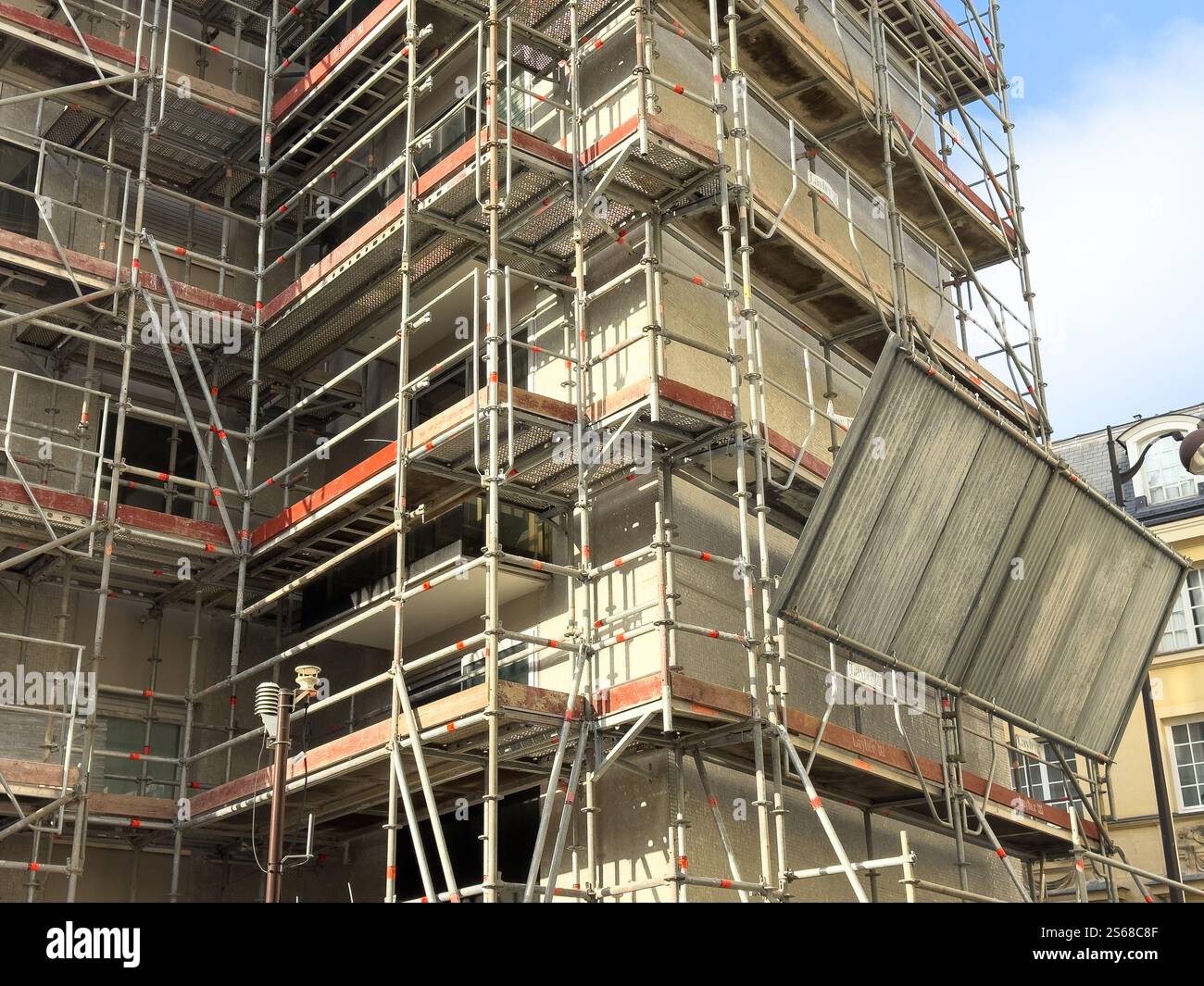 Construction of a multi-story building with scaffolding and safety ...