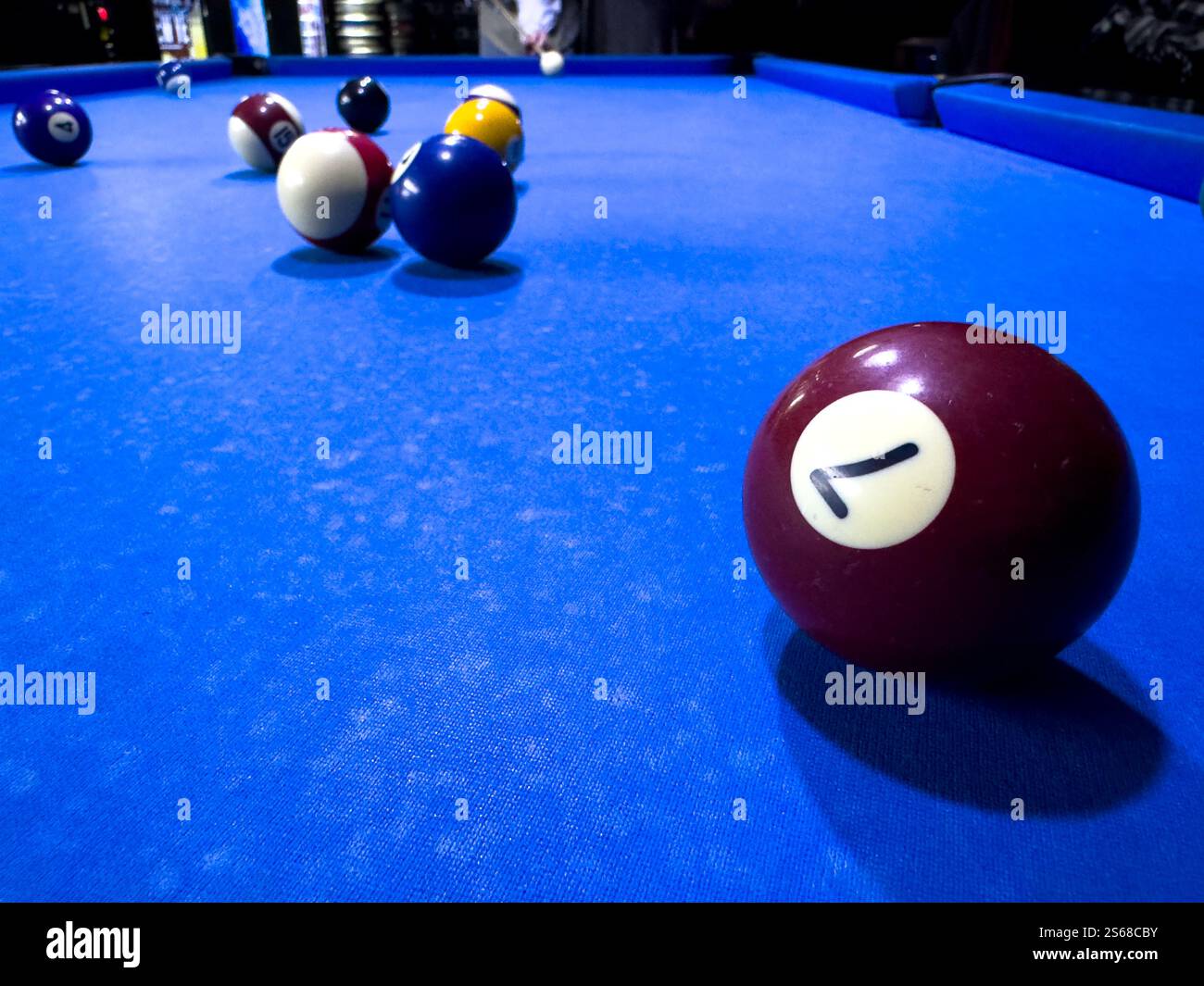 Players engage in a lively game of billiards at a local pool hall Stock ...