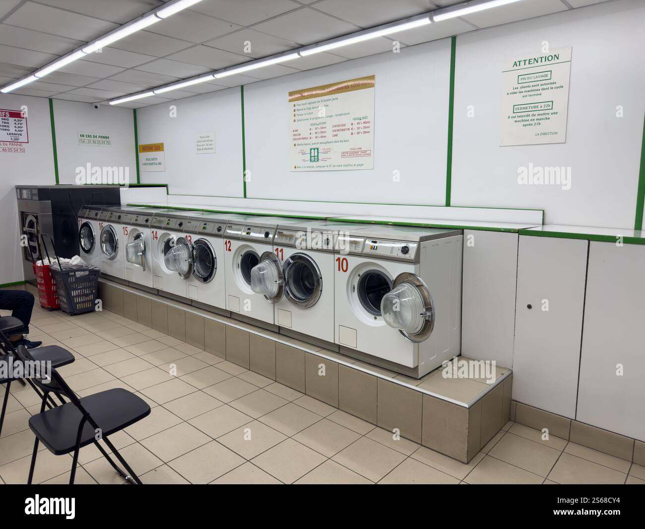 Modern laundromat with clean, spacious interior and many machines Stock ...