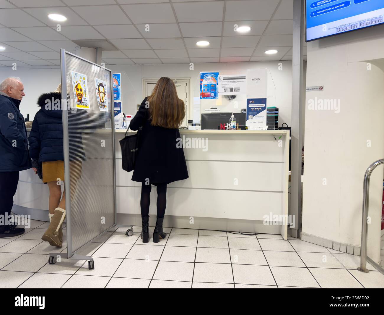People engaging at a service counter in a modern office environment ...