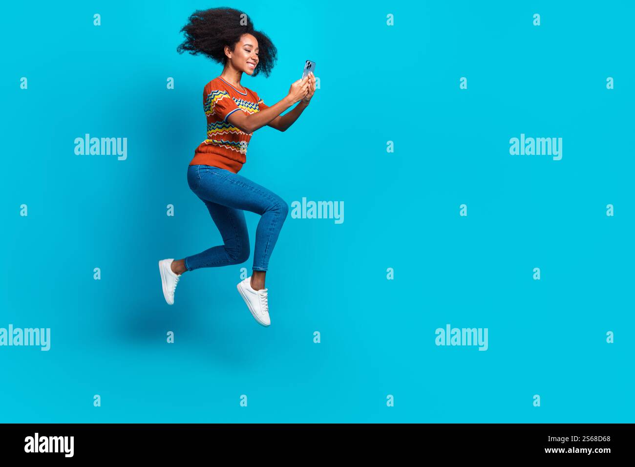 Full body length photo of crazy jumping young girl cant stop using ...