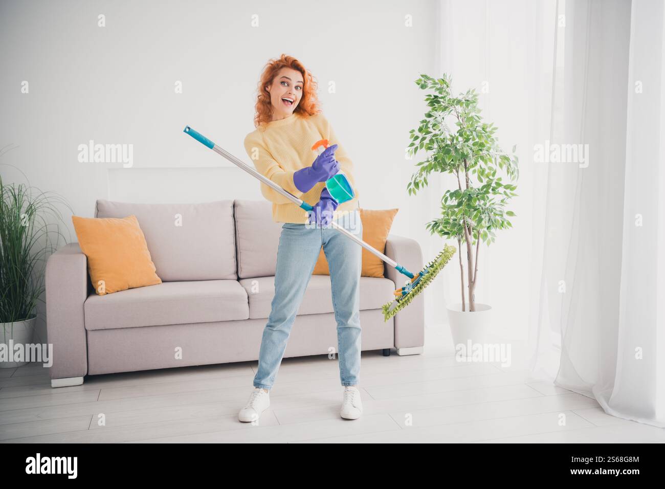 Photo of shiny cute girl dressed yellow jumper enjoying washing floor ...