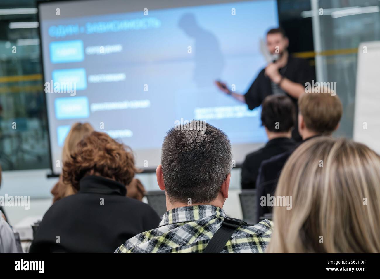 Professional speaker delivers business presentation to attentive ...