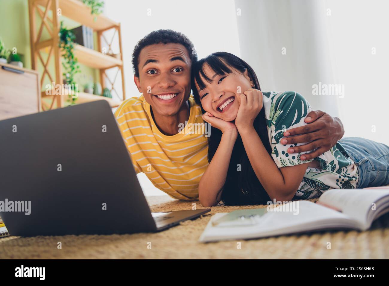 Photo of lovely cute pretty couple lying floor cuddling learning from ...