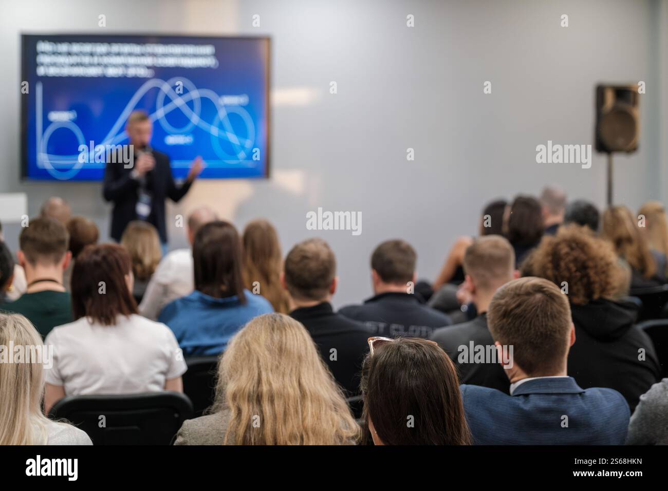 Professional speaker engaging audience during business conference ...