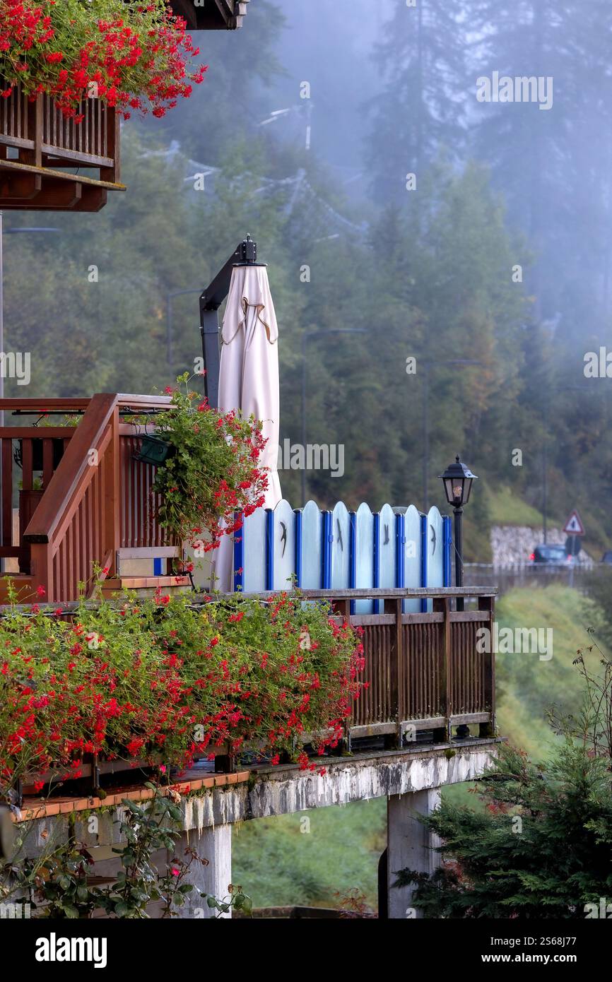 Outdoor cafe terrace with flowers and umbrella in European Alps ...