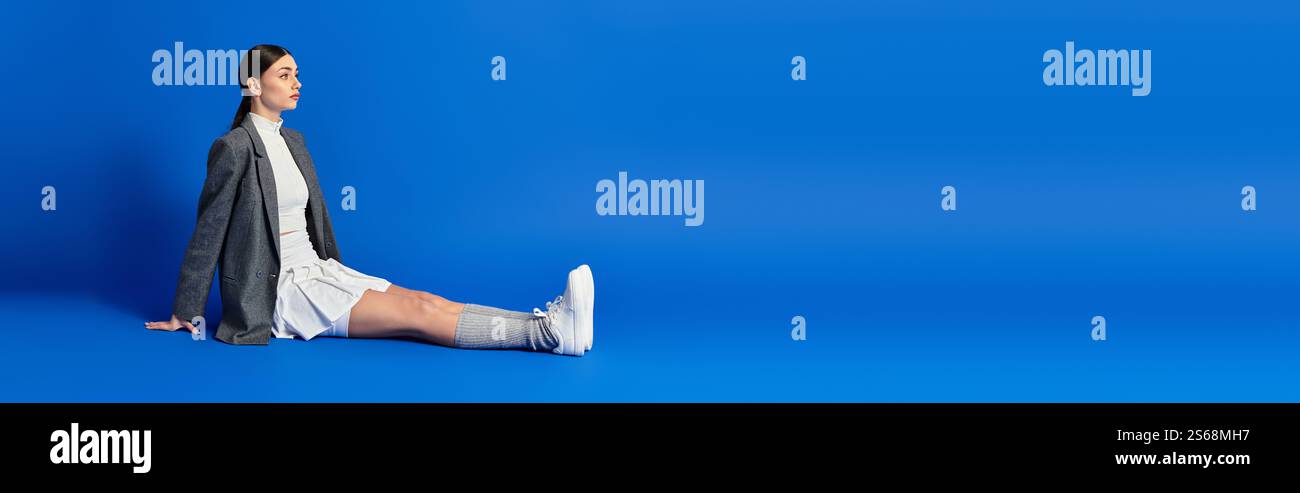 With a poised expression, a young woman enjoys a moment of reflection ...