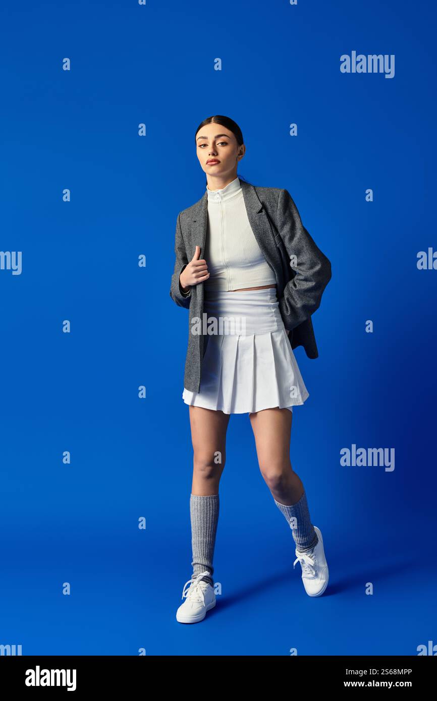 Emotional young woman strides confidently in a stylish outfit ...