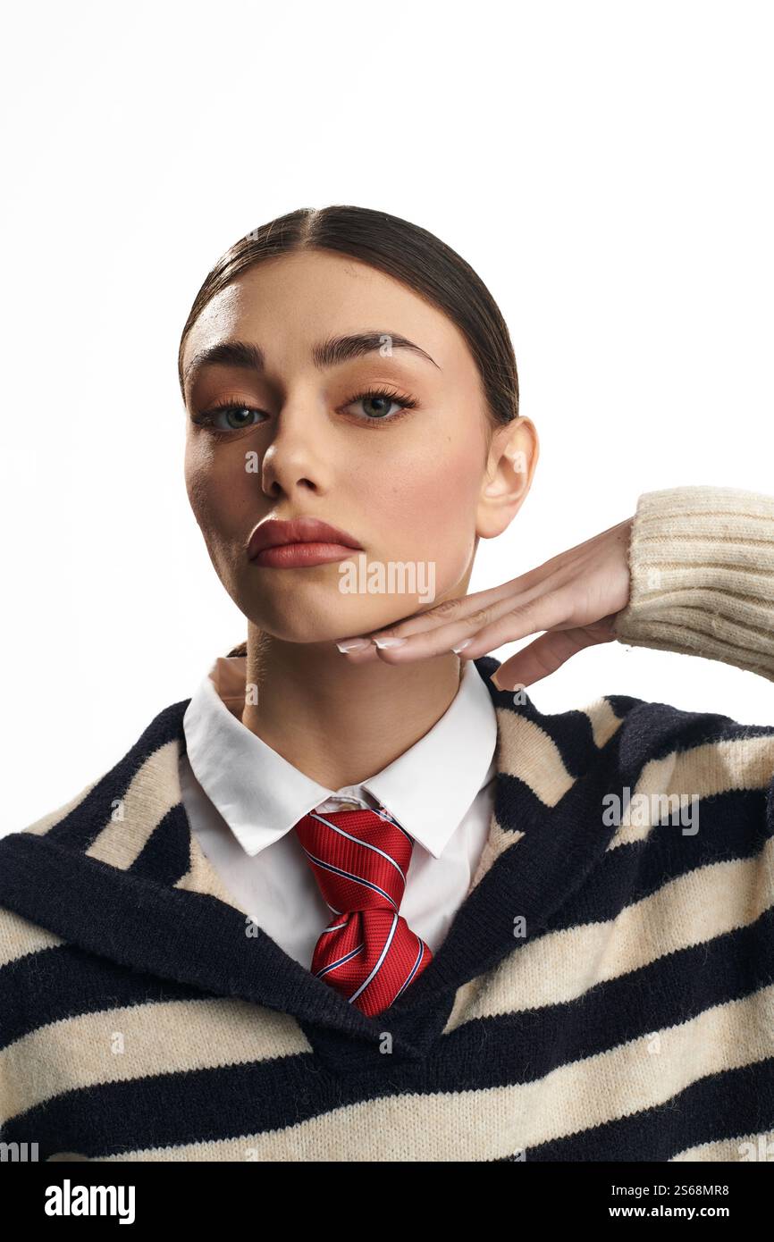 A young woman displays her beauty and emotions in stylish attire ...